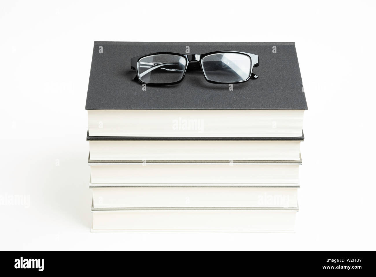 A neatly stacked set of five monochromatic cloth-bound books with ...
