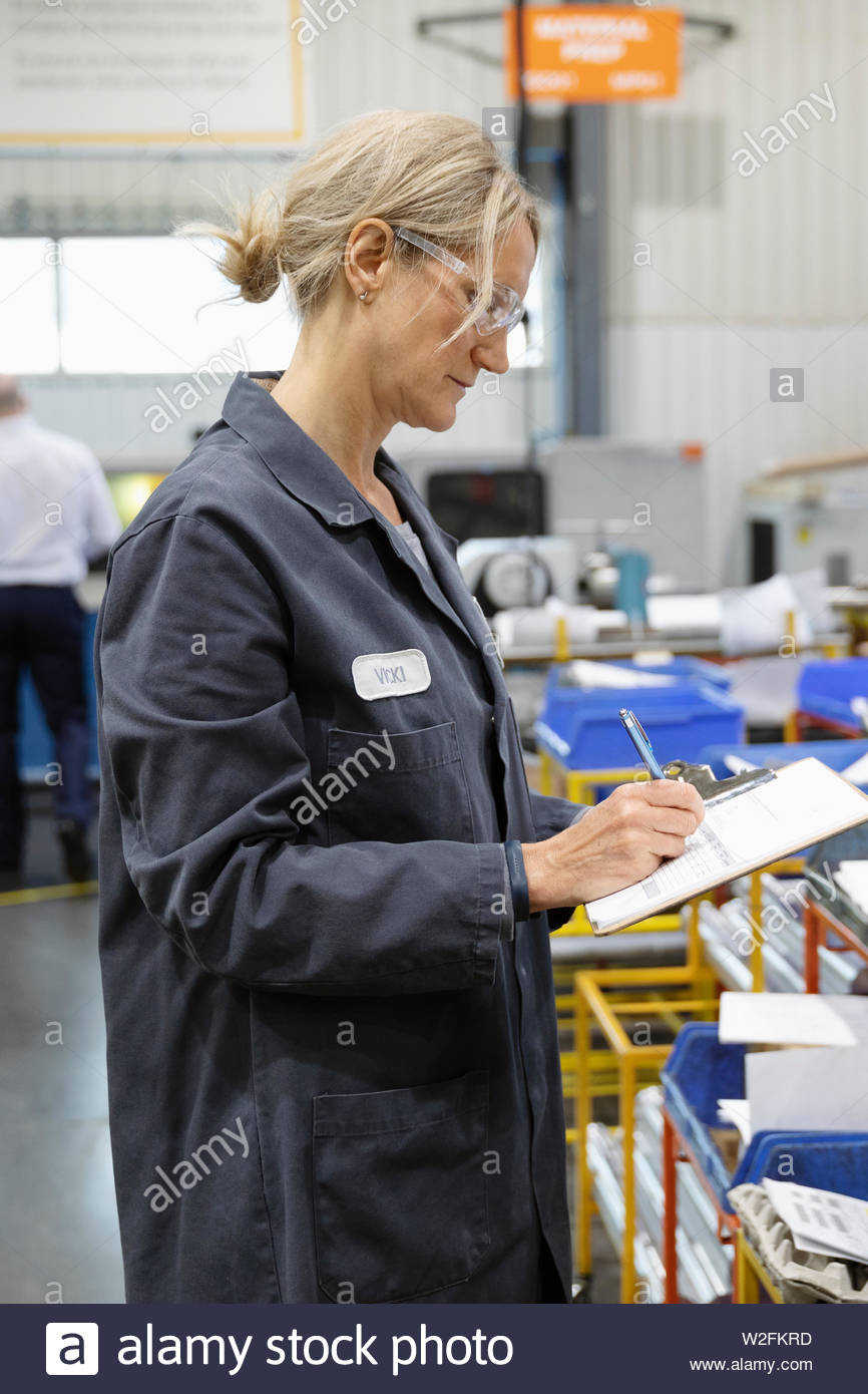 Woman taking inventory in warehouse hi-res stock photography and images ...