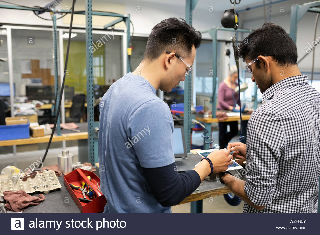 Two engineers looking at computer hi-res stock photography and images ...