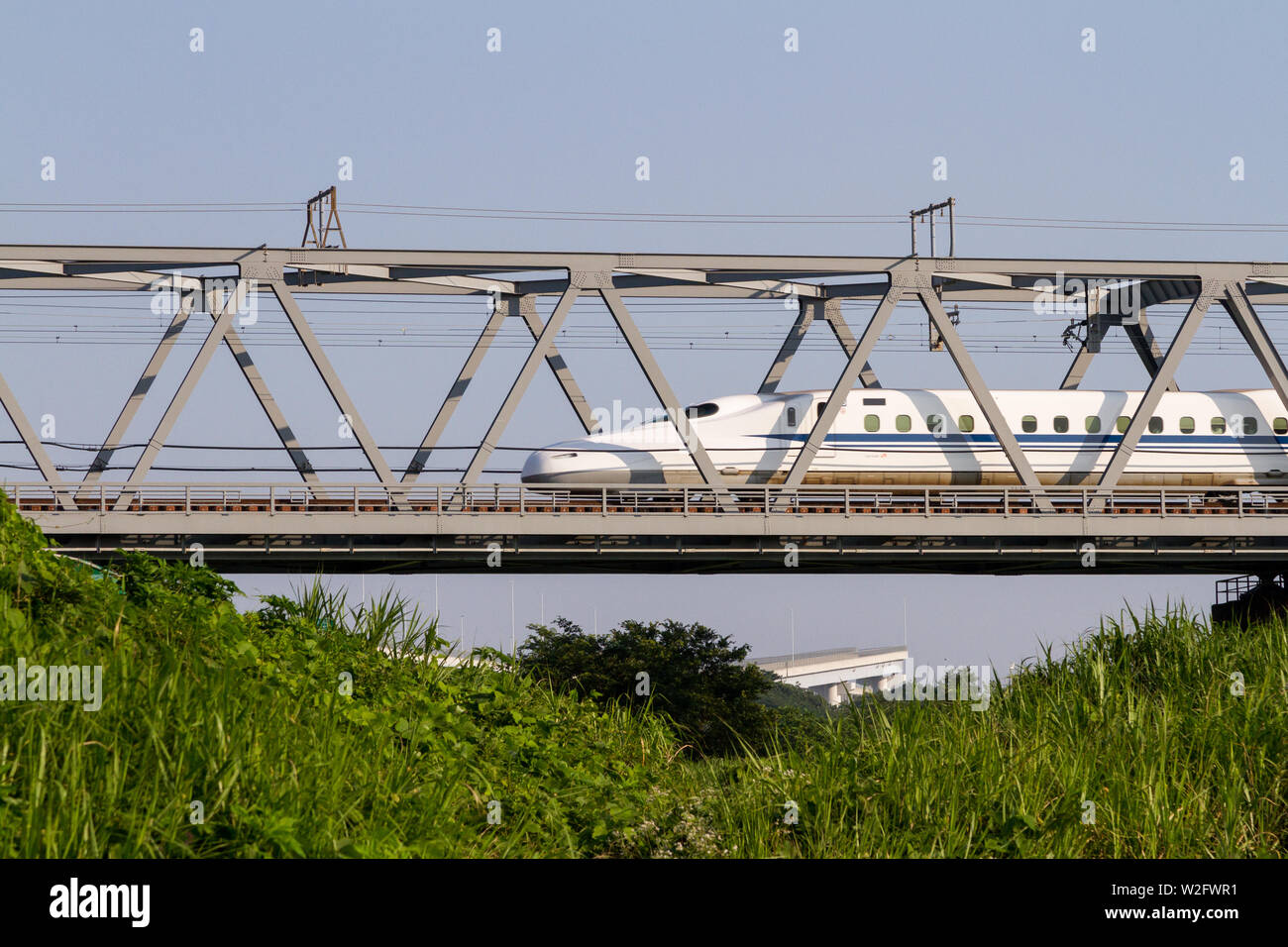 An N700 series shinkansen (bullet train) on a bridge near Samukawa in ...