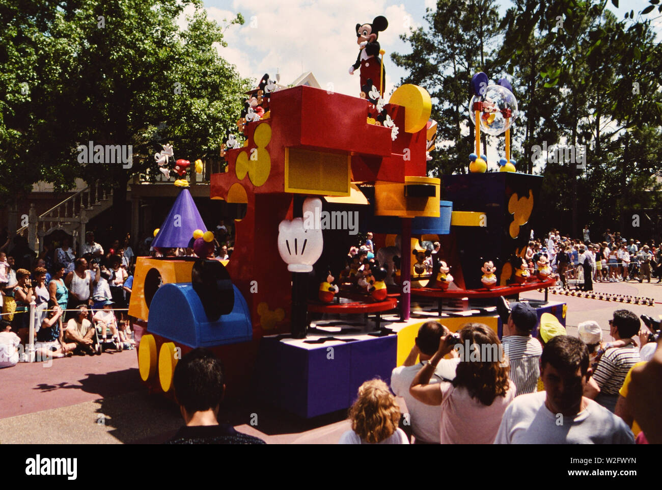 Mickey Mouse atop a Disney float in a parade featured at a Disney theme ...