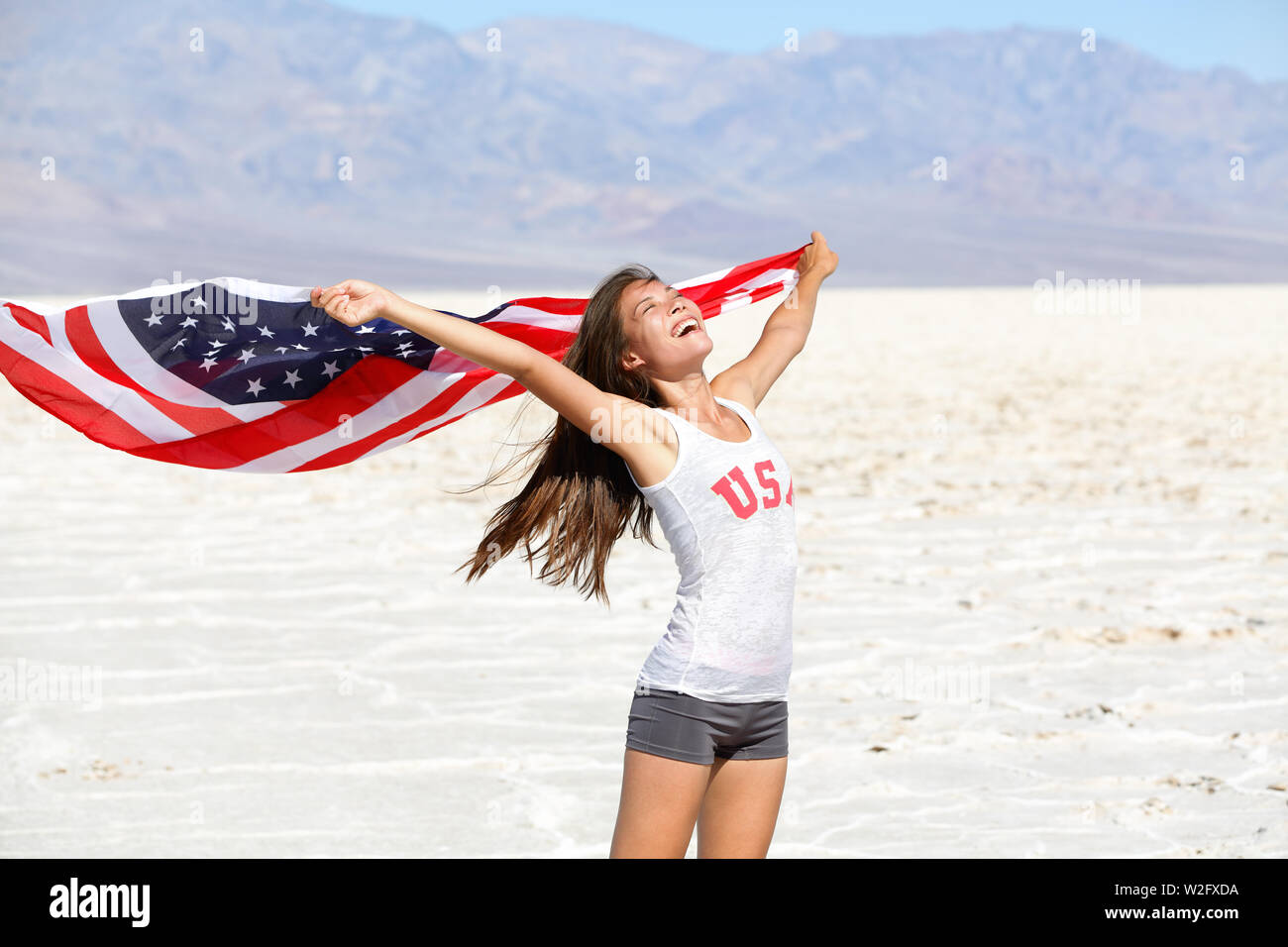 USA flag - woman athlete showing american flag. US sport athlete winner ...