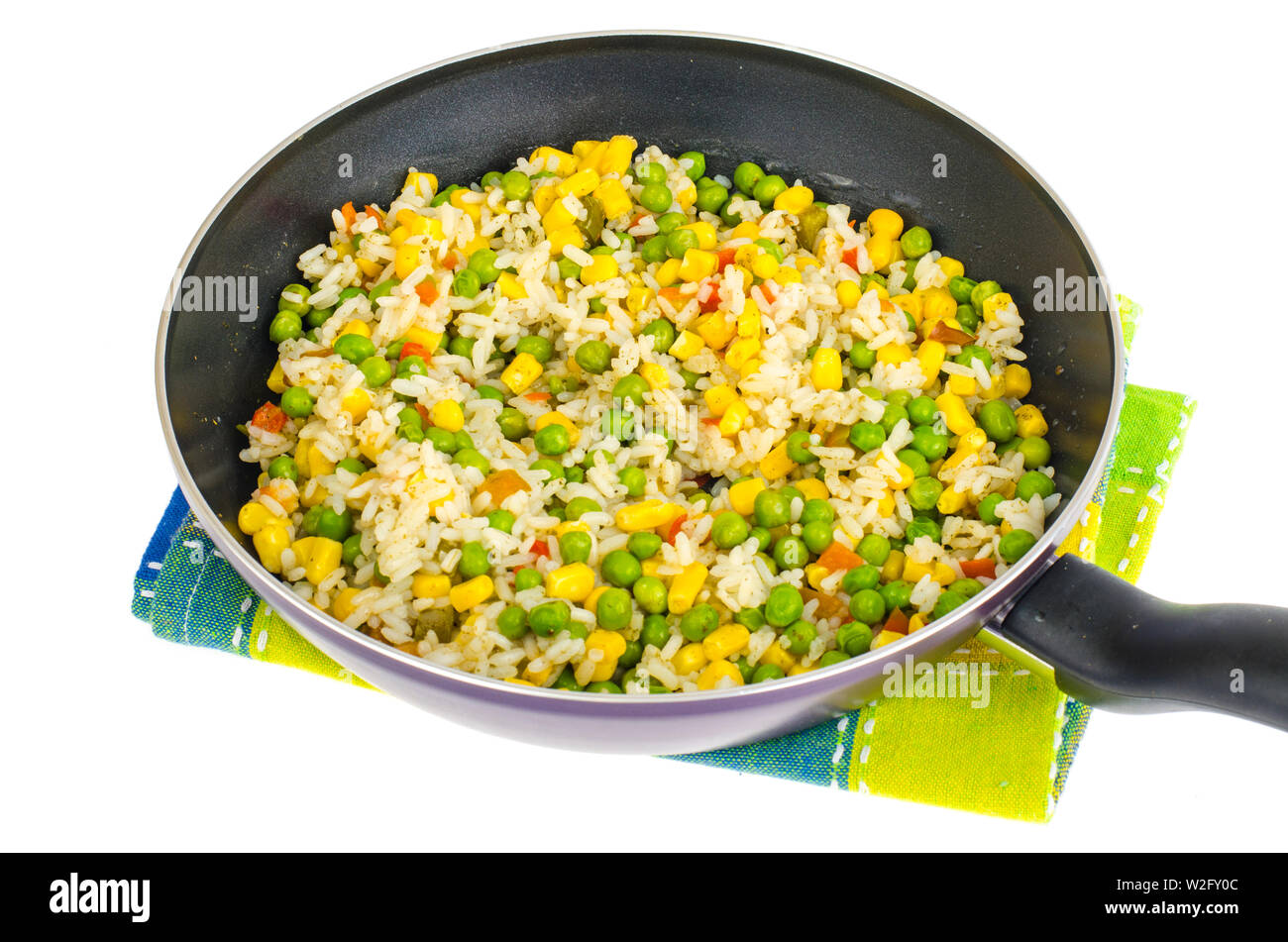 Stewed rice with corn, green peas in pan on white background Stock ...