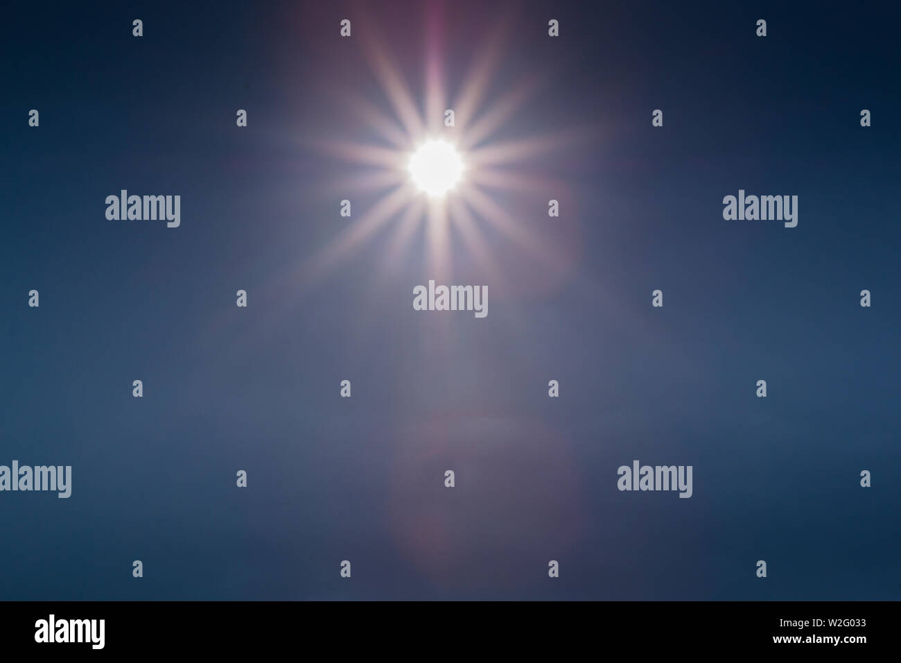 Shining sun at clear blue sky with blank space Stock Photo - Alamy