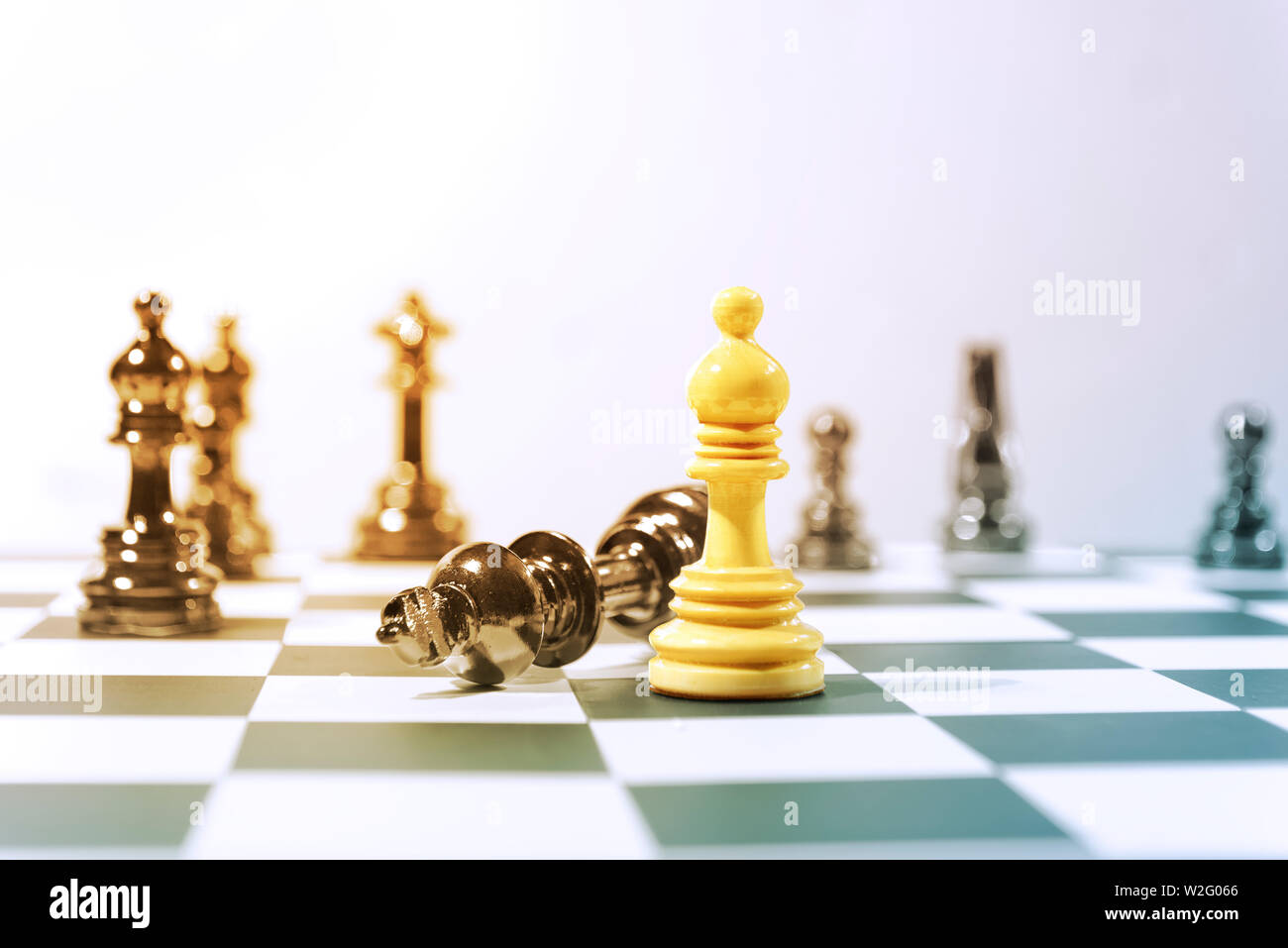 Black king chess piece defeated by brown bishop chess piece on the ...