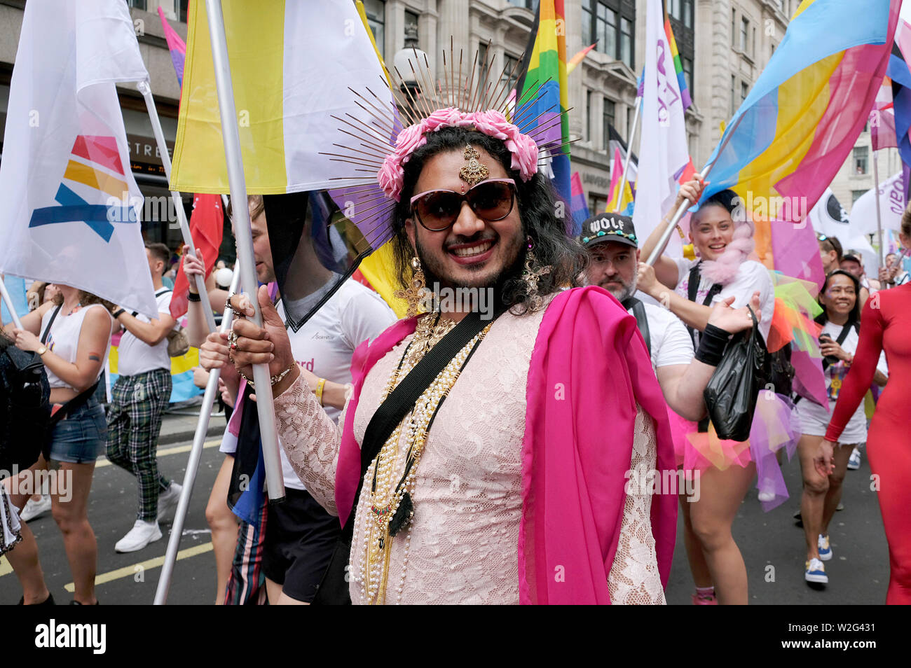 Participant smiles to the camera during the parade.Thousands of ...