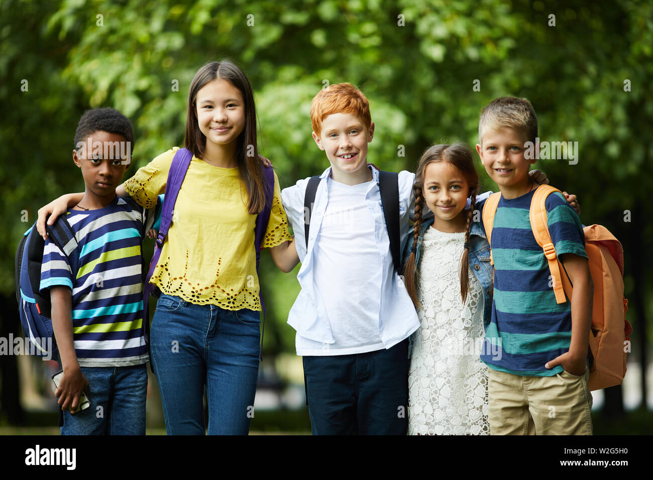 Group of positive multi-ethnic classmates in casual clothing wearing ...
