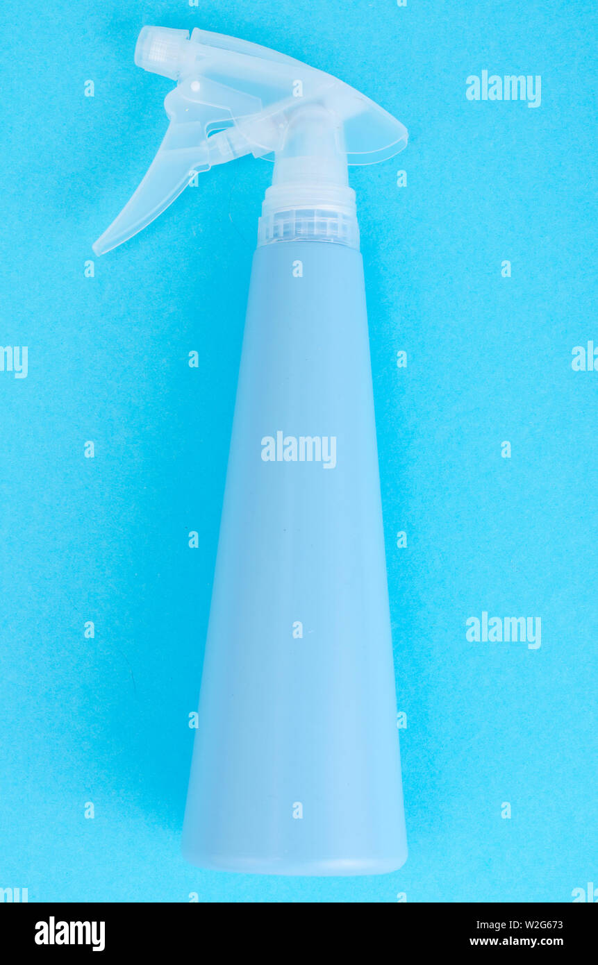 Blue bottle spray on bright background Stock Photo - Alamy