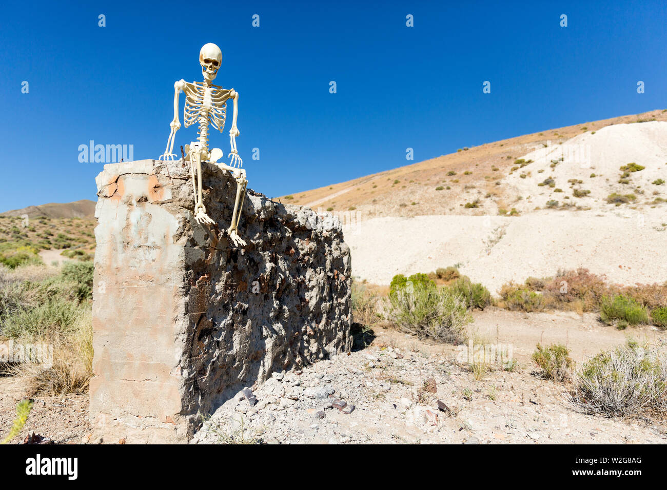 Skeleton posing in mining ruins in the desert on a hot day Stock Photo ...