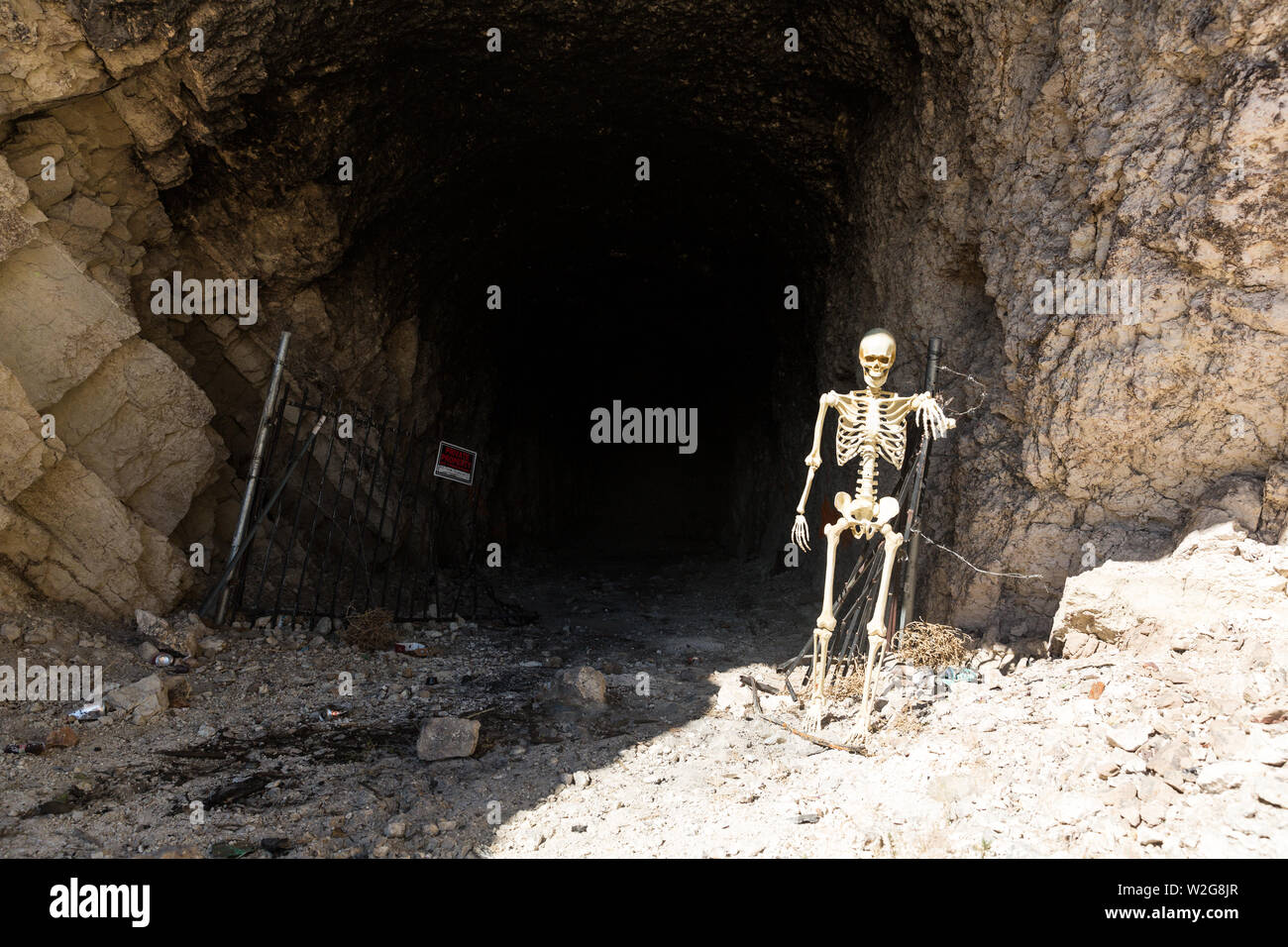 Skeleton in the mouth of a mine in the desert Stock Photo - Alamy