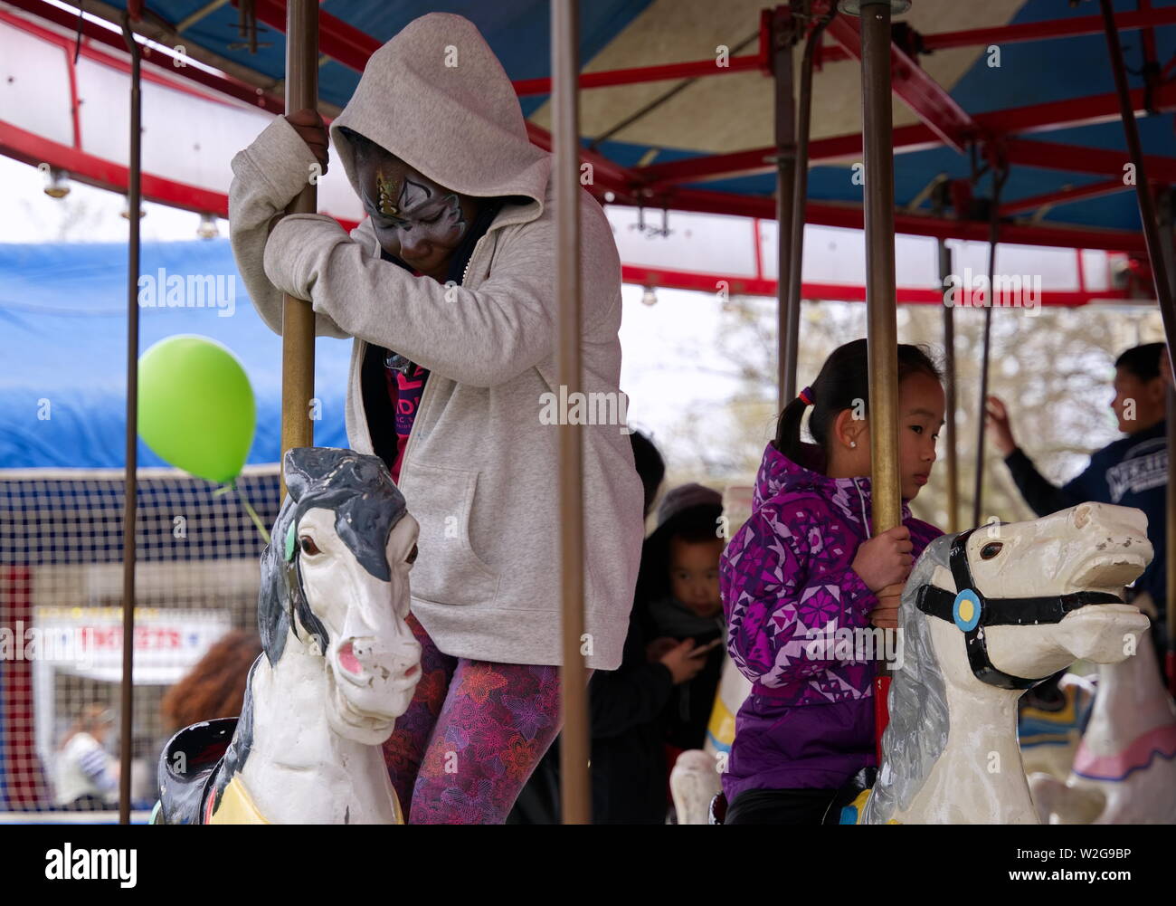 Girl riding on merry go round hi-res stock photography and images - Alamy