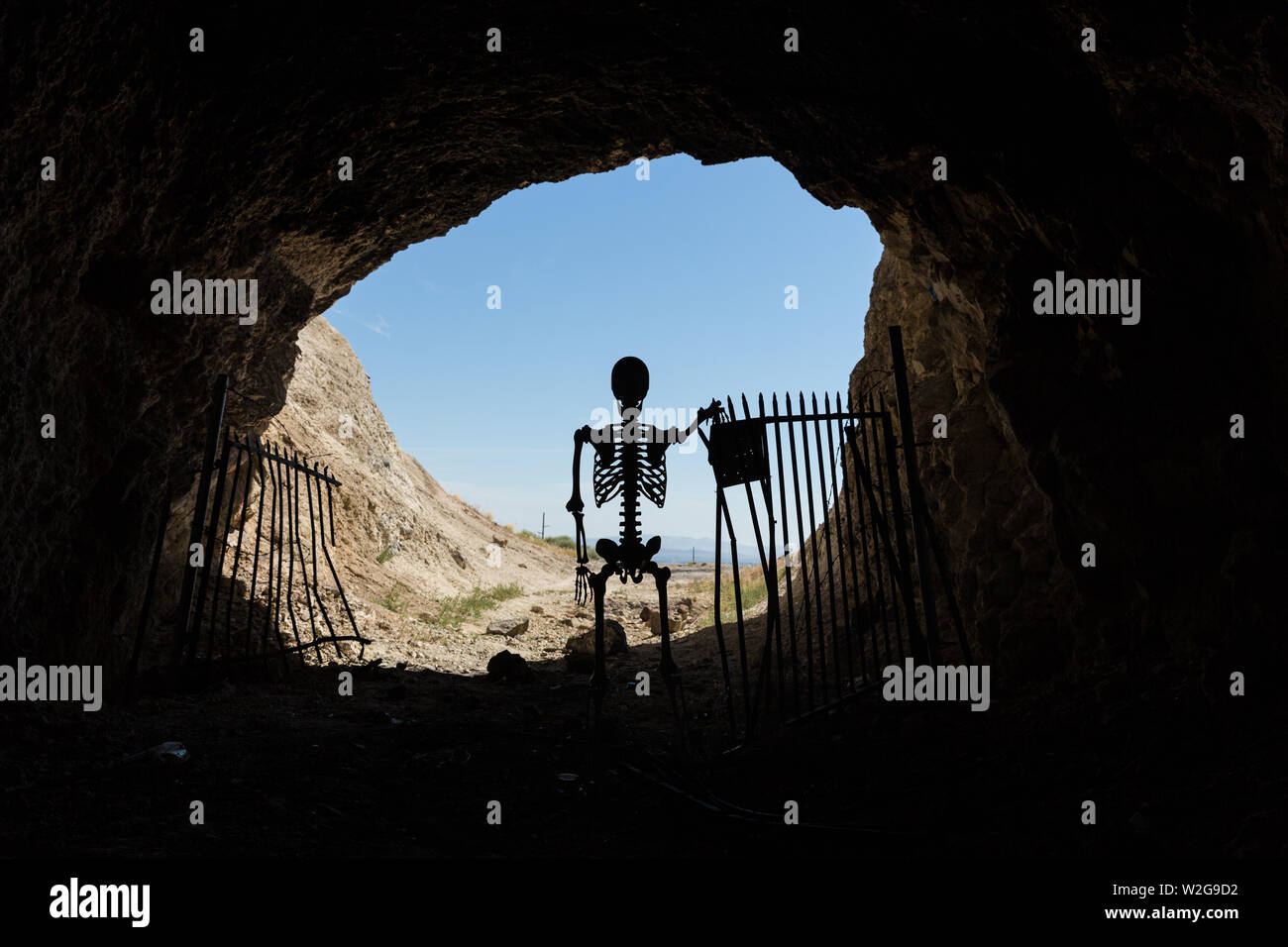 Skeleton silhouette in the mouth of a gated mine stay out stay alive ...