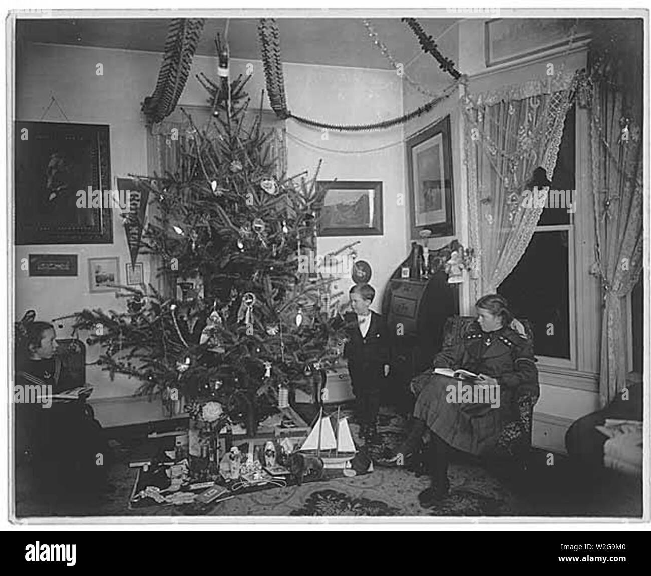 Children posed around a Christmas tree probably the Warner family ...