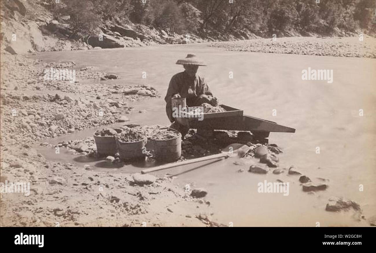 Chinese Man Mining Along River Stock Photo - Alamy