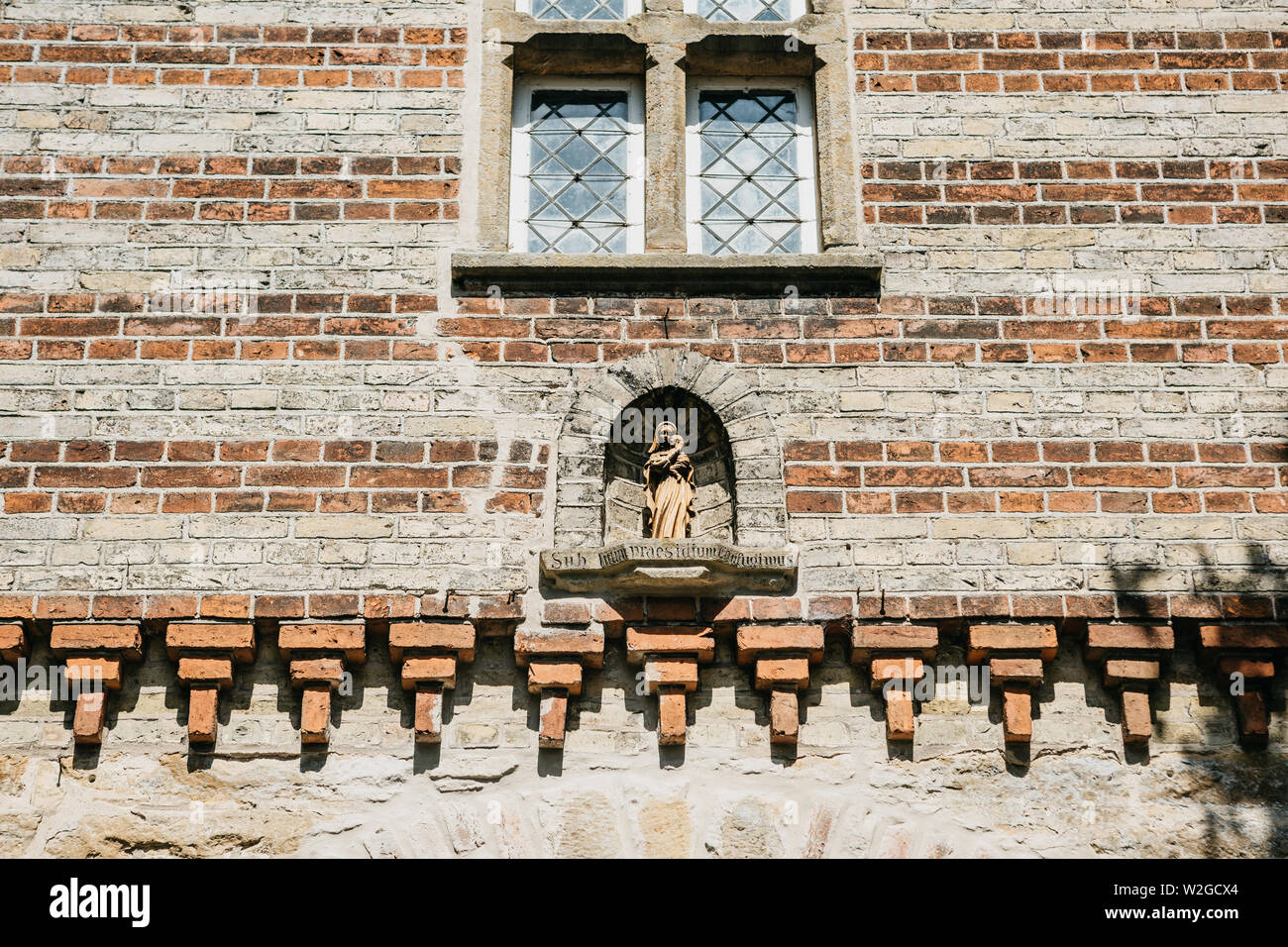 Virgin Mary with a baby in her arms as a decoration on a building or an ...