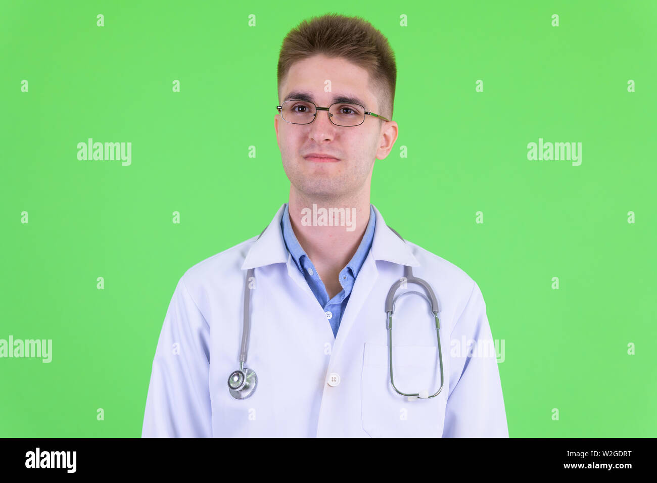 Face of young handsome man doctor thinking Stock Photo - Alamy
