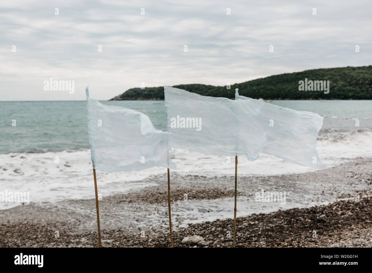 View of the turbulent sea in windy weather or strong wind. White flags ...