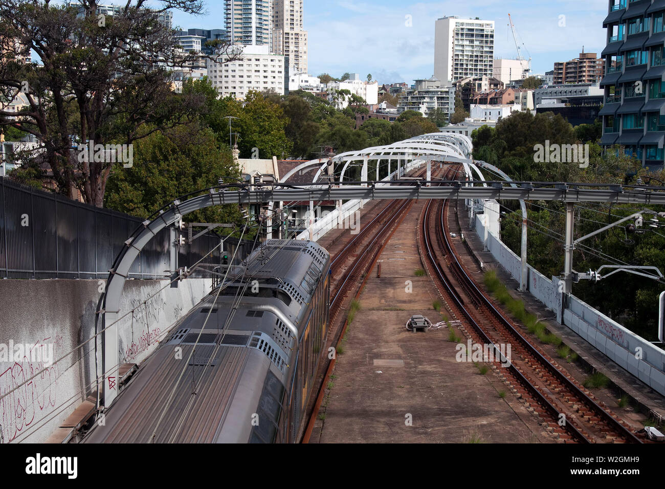 Sydney Australia, electric train moving away along suburban train track ...