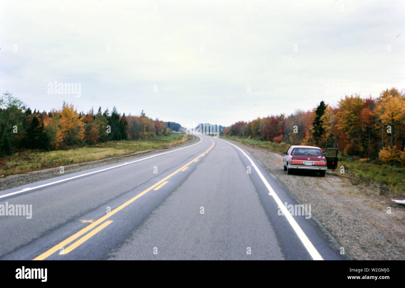 Car pulled over to the side of a road ca. 1986 Stock Photo - Alamy