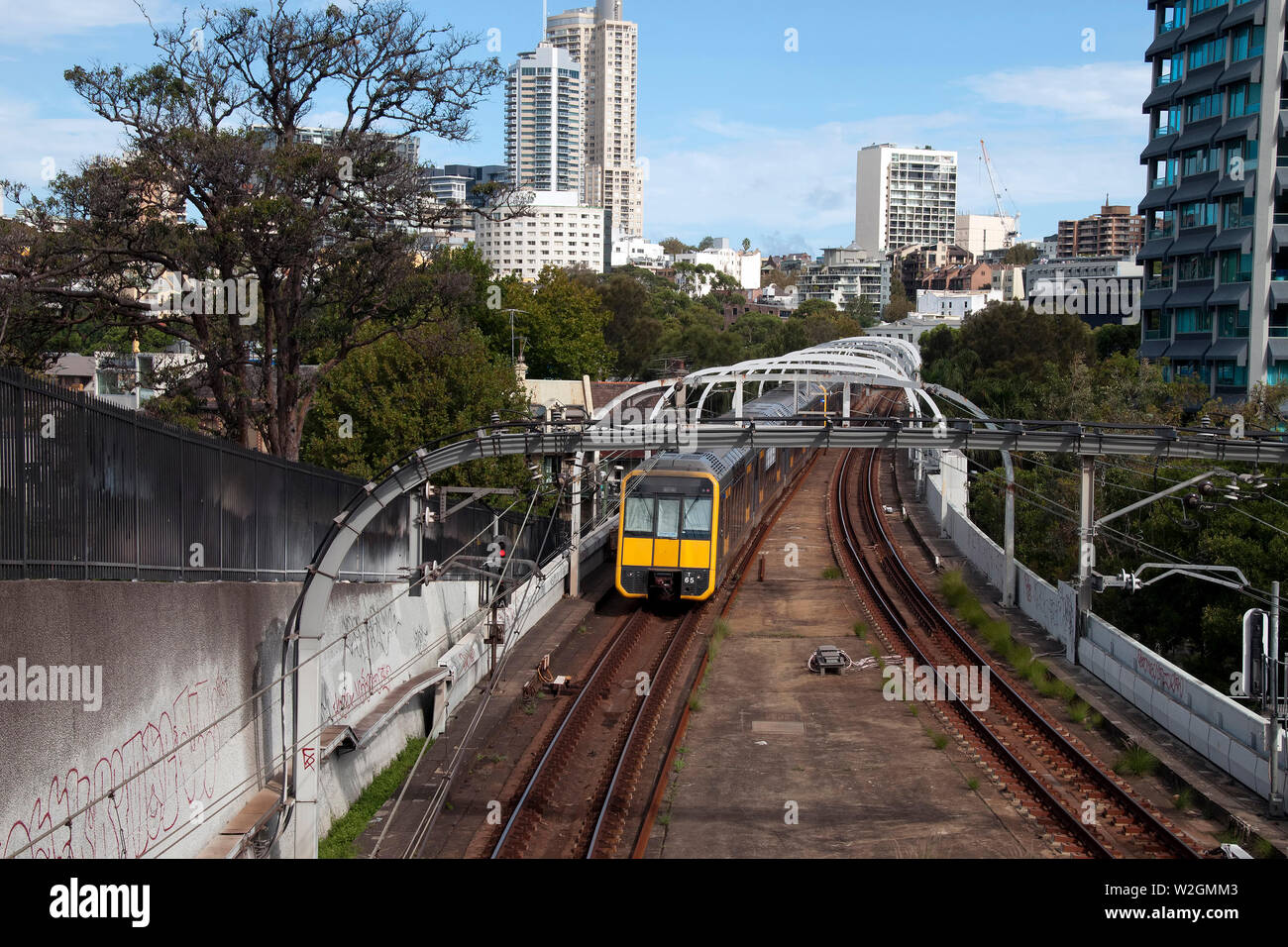 Sydney Australia, electric train moving away along suburban train track ...