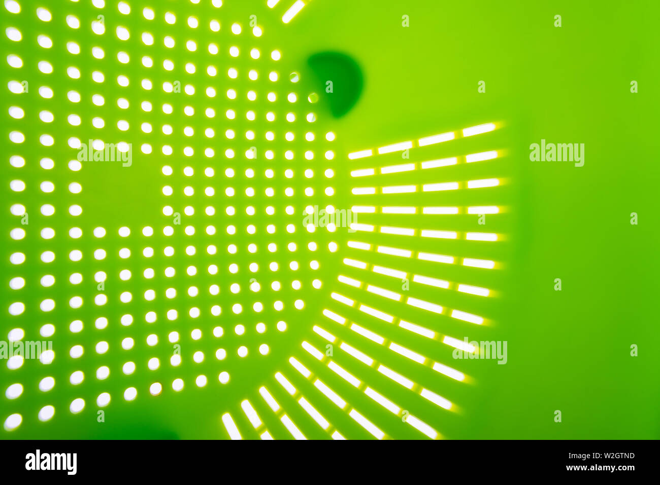 Close-up of a green plastic colander, a kitchen utensil to drain pasta ...
