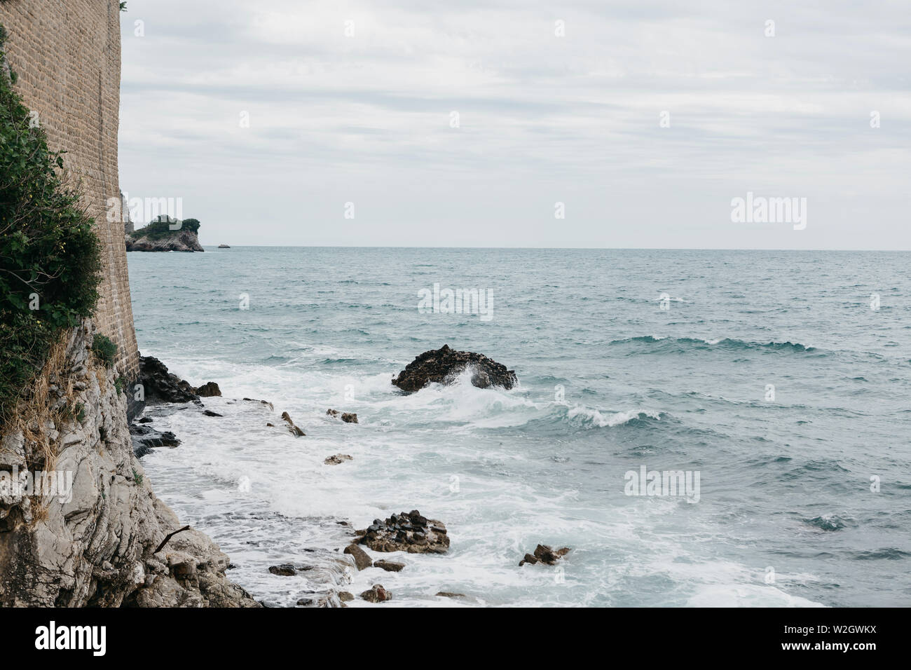 Restless sea near the stone coast. Surf. Natural landscape. Next to the ...