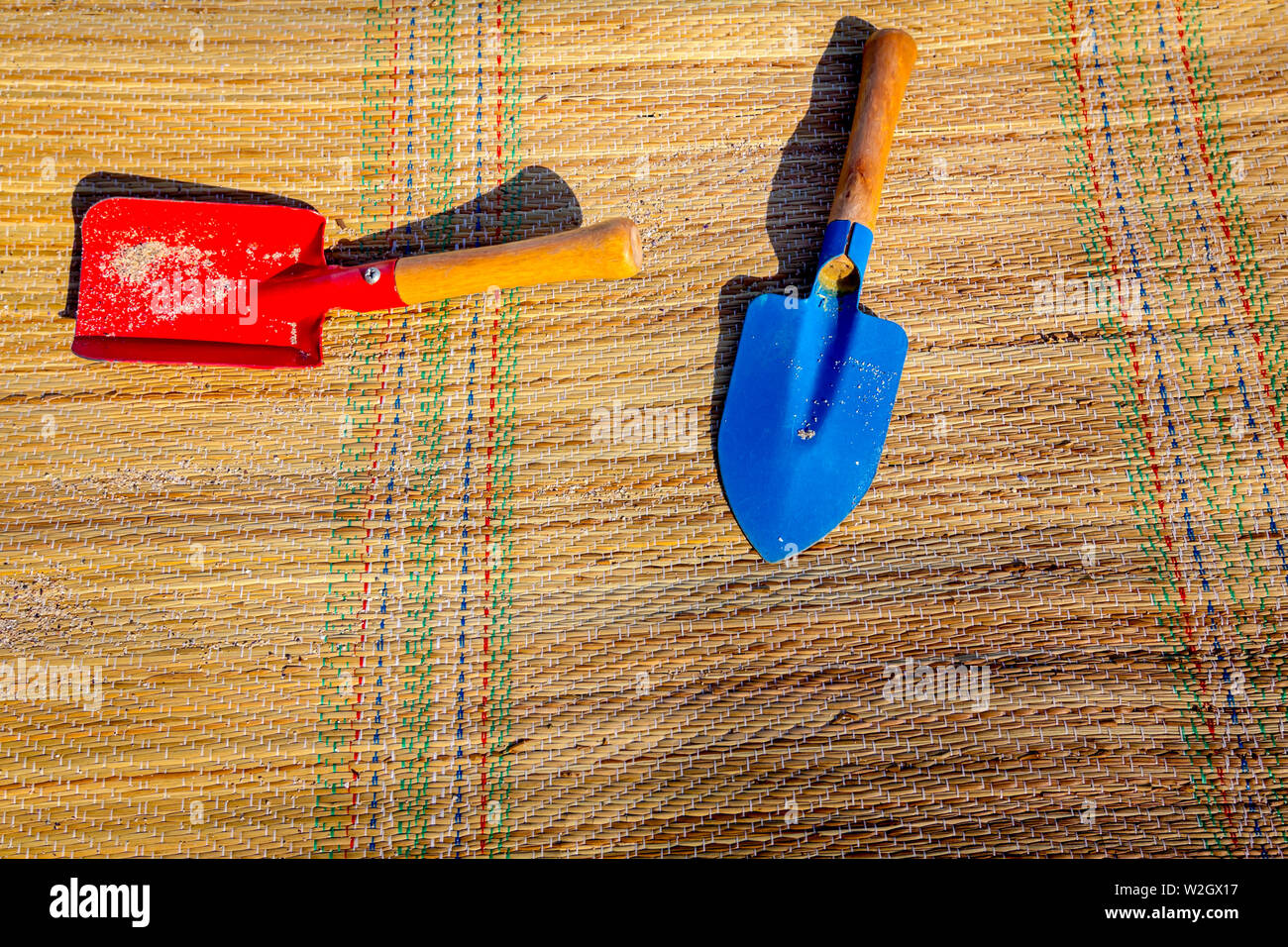 Small spade and shovel on mat for digging sand on the beach Stock Photo ...