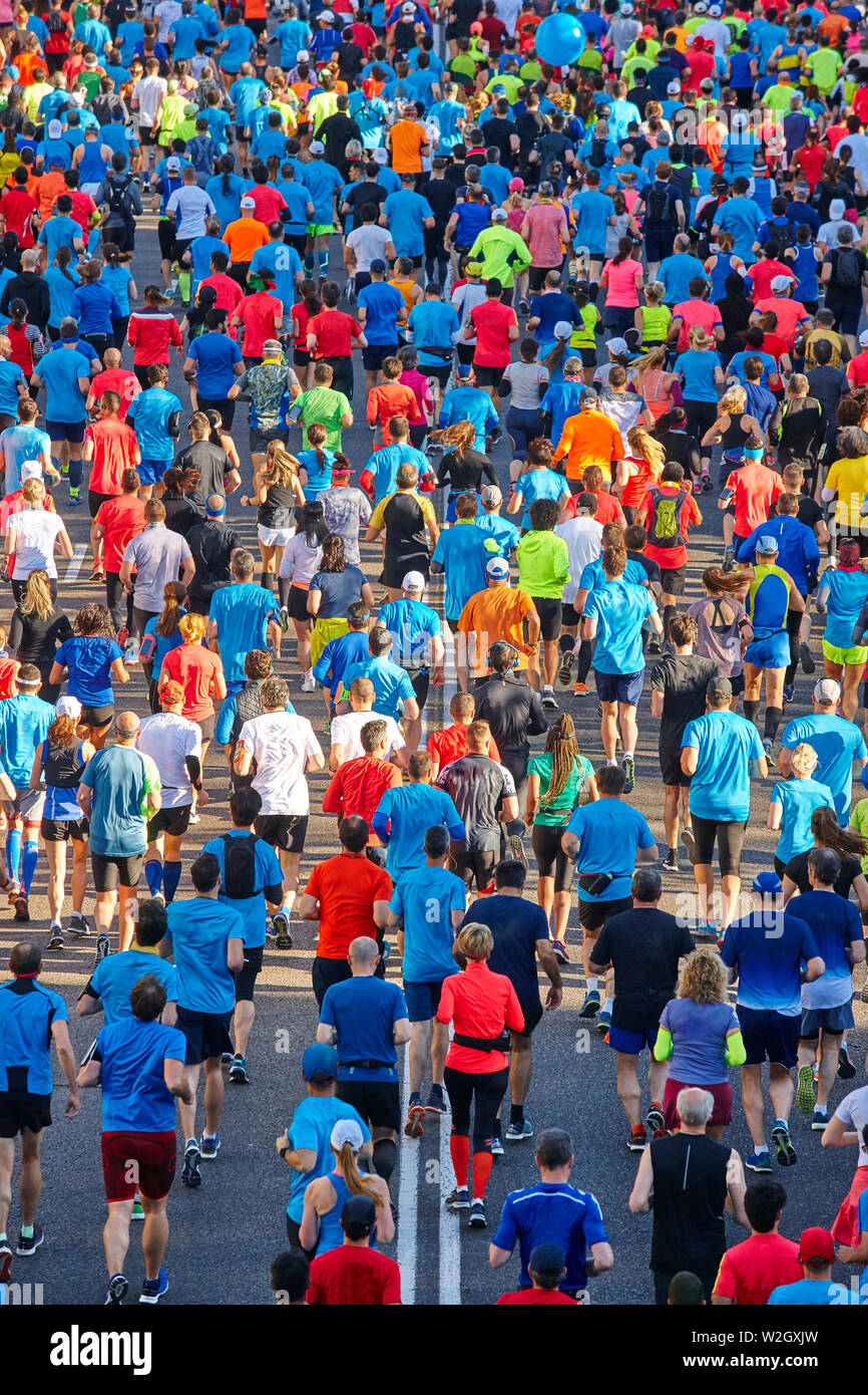 Runners on the street. Athletes in motion. Urban competition. Vertical ...