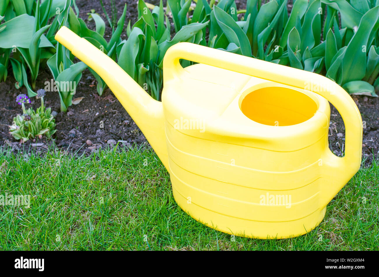 Yellow watering can container container hi-res stock photography and ...