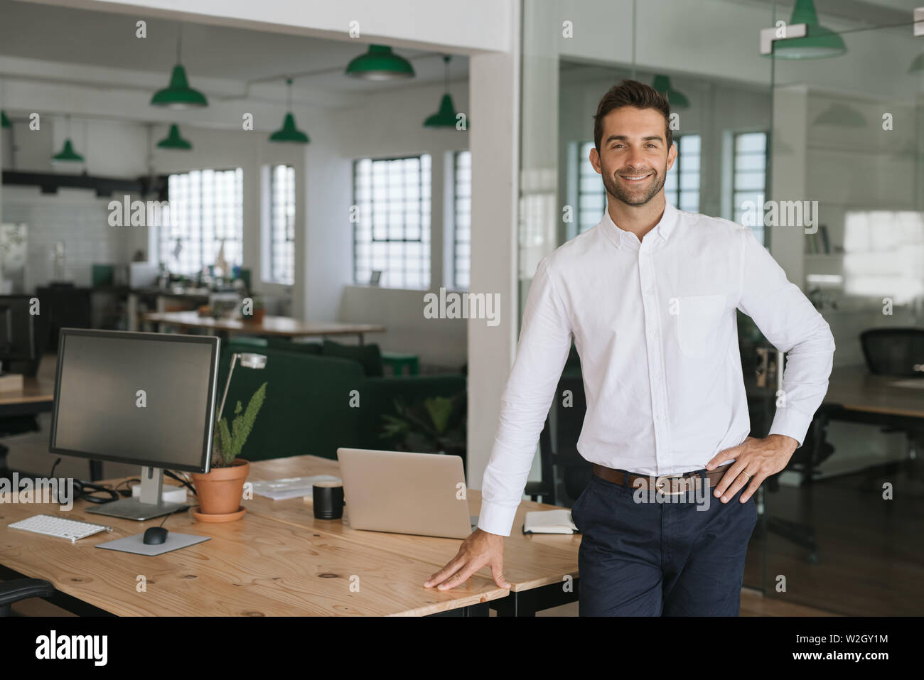 Young man leaning against table hi-res stock photography and images - Alamy
