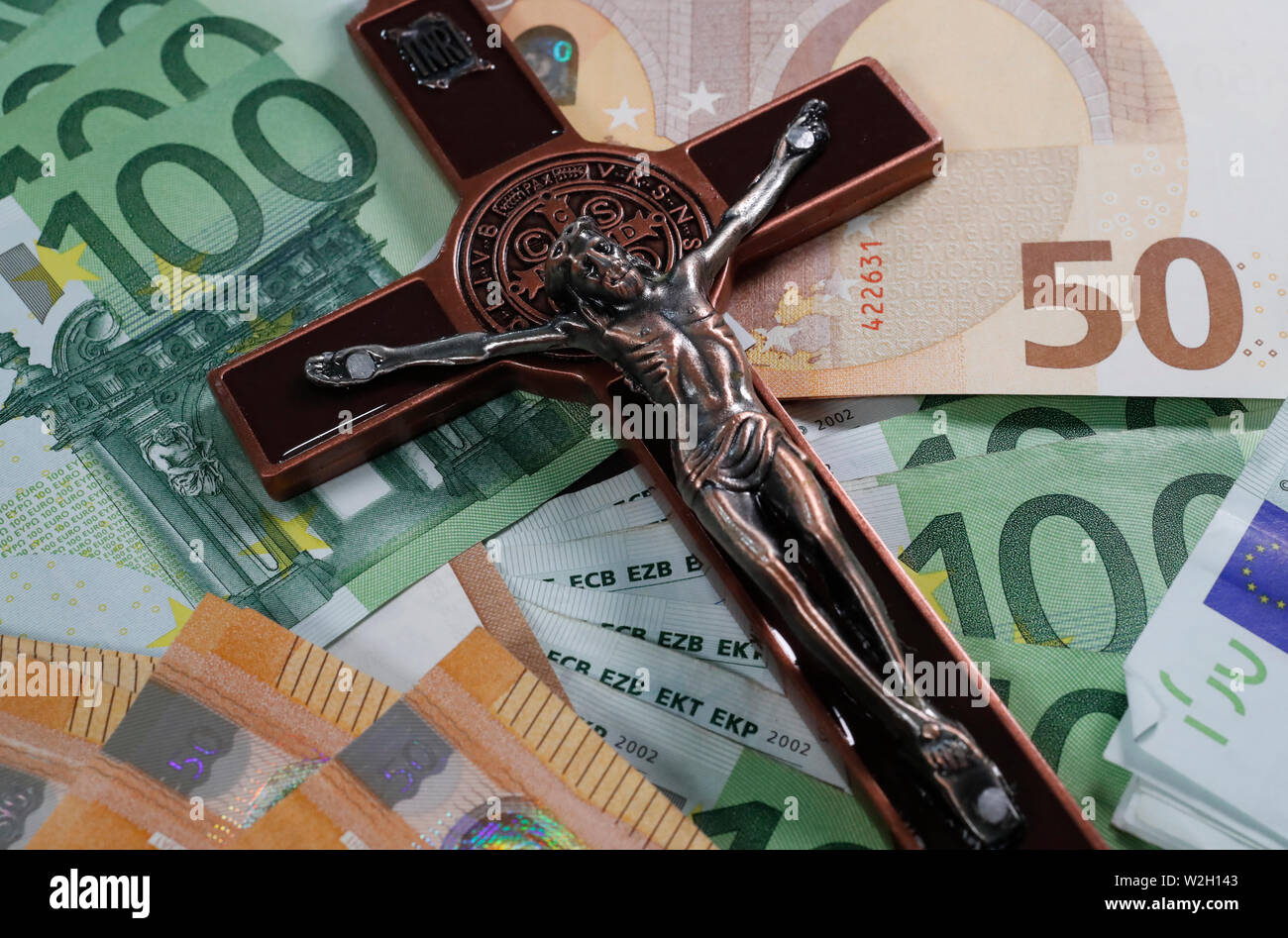Catholic finance and economy concept with crucifix. Banknotes of euro ...