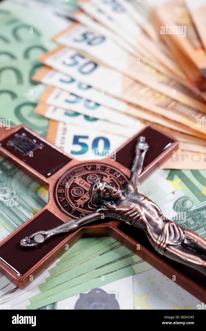 Catholic finance and economy concept with crucifix. Banknotes of euro ...