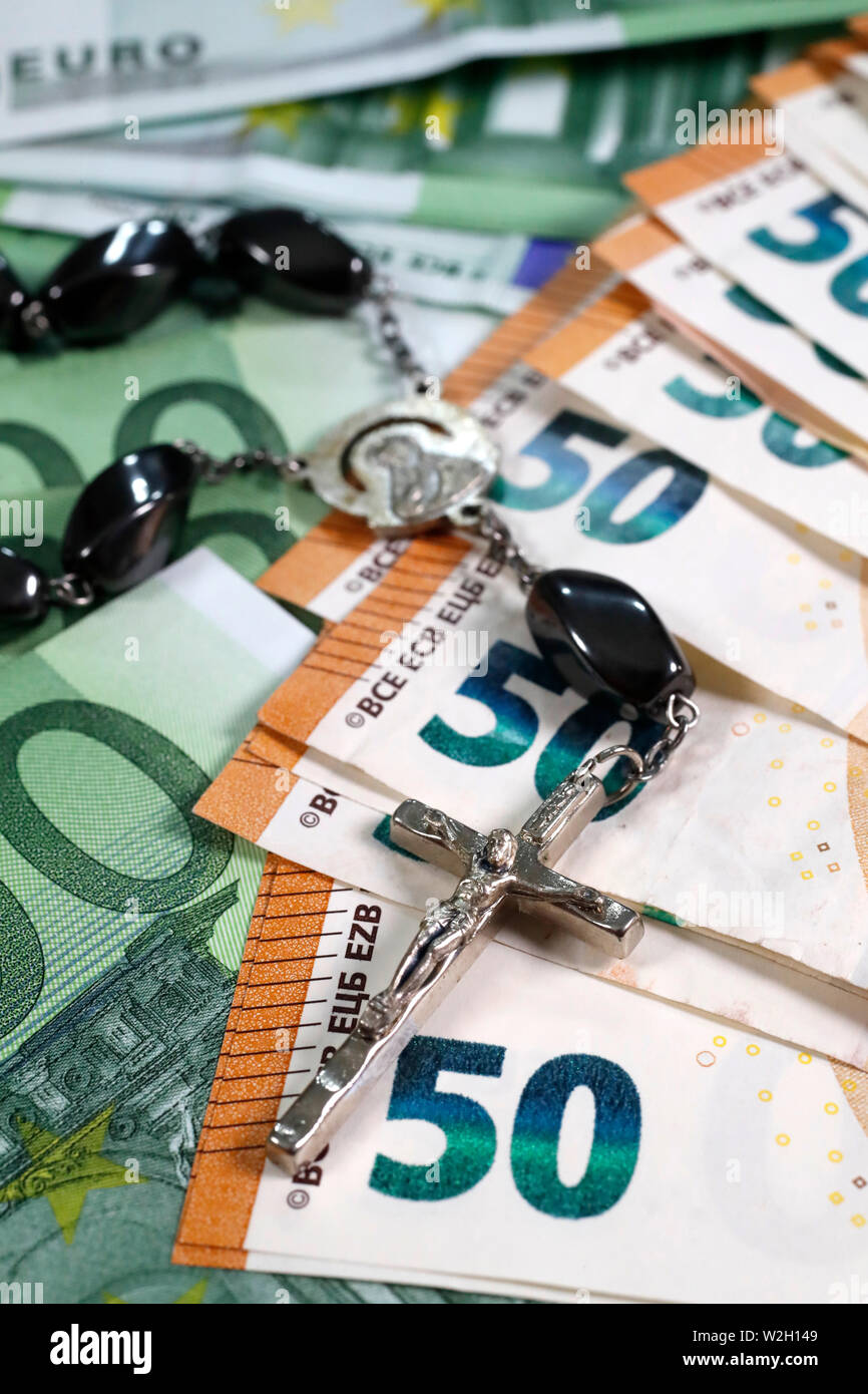 Catholic finance and economy concept with rosary. Banknotes of euro ...