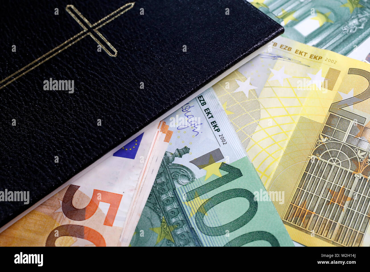 Catholic finance and economy concept with bible. Banknotes of euro ...