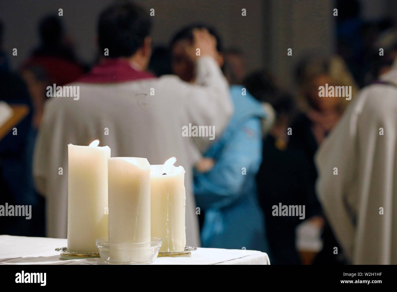 Ash Wednesday. A priest marks a cross of ashes on a worshipper's ...
