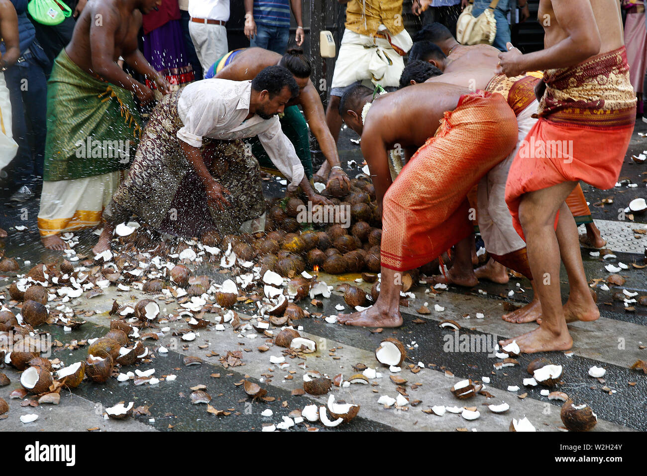 Ganesh festival in Paris, France. Coconut smashing Stock Photo - Alamy