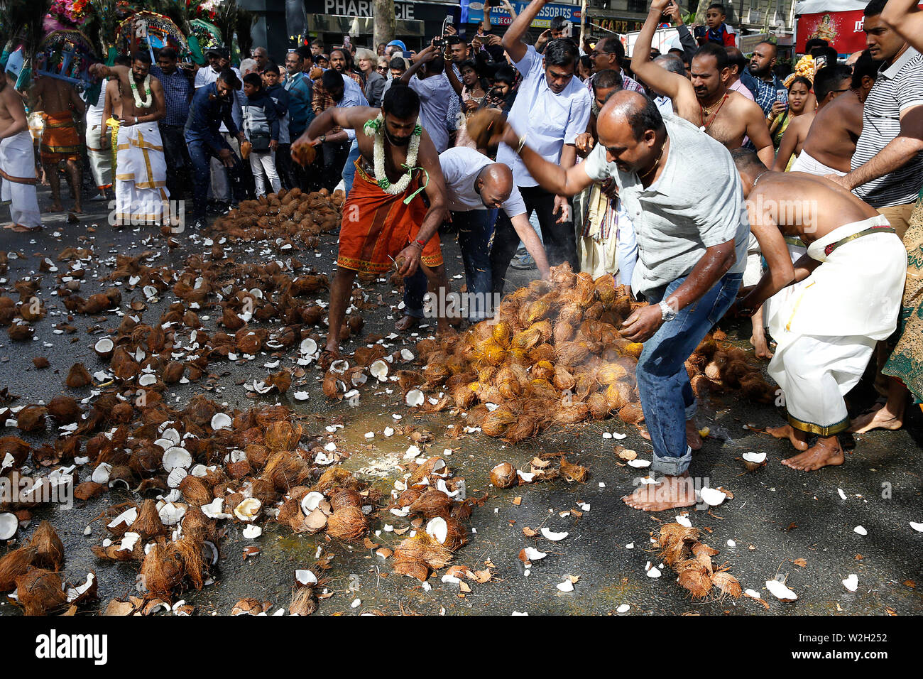 Ganesh festival in Paris, France. Coconut smashing Stock Photo - Alamy
