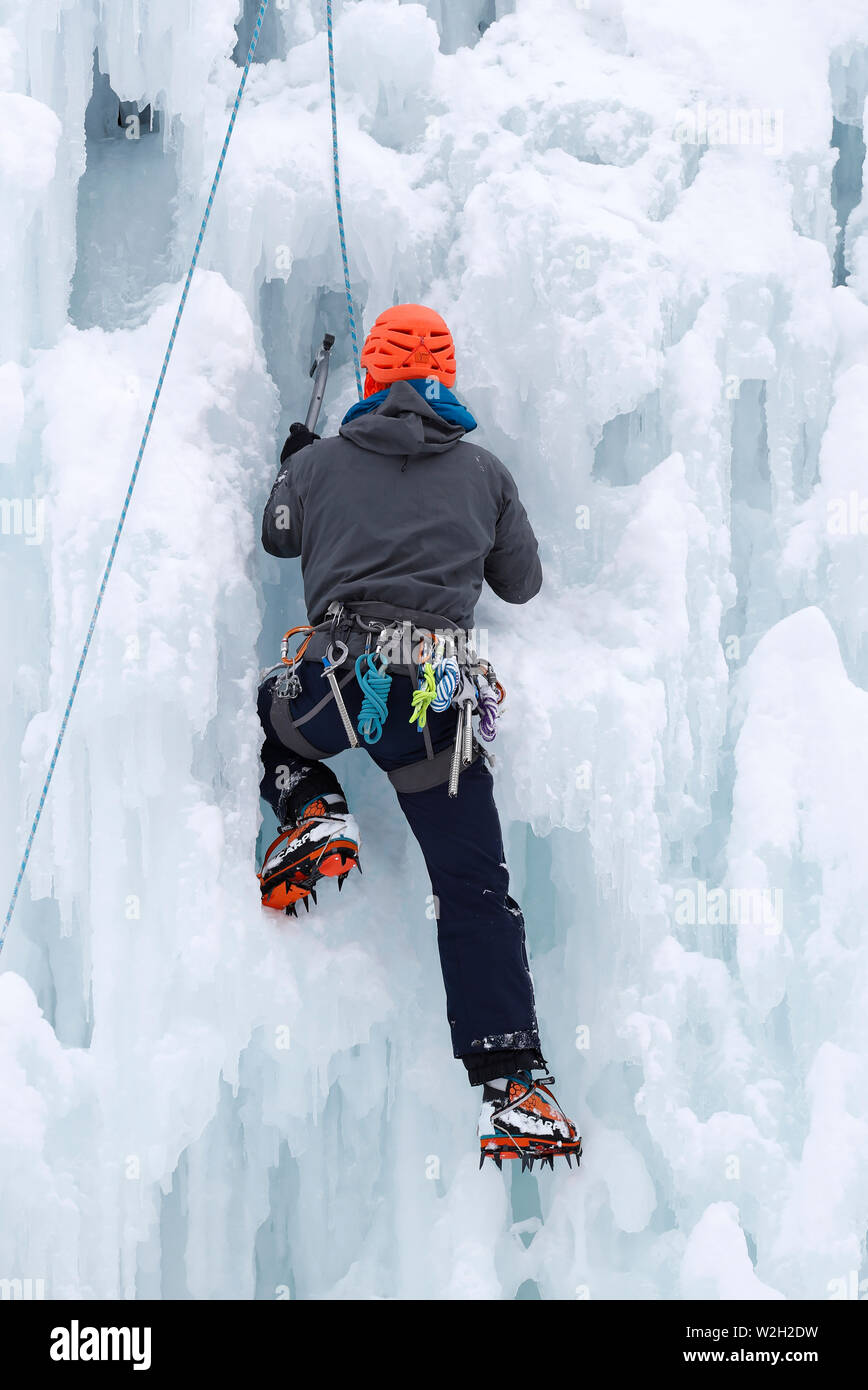 French Alps. Frozen waterfall. Man ice climbing. Les Contamines. France ...