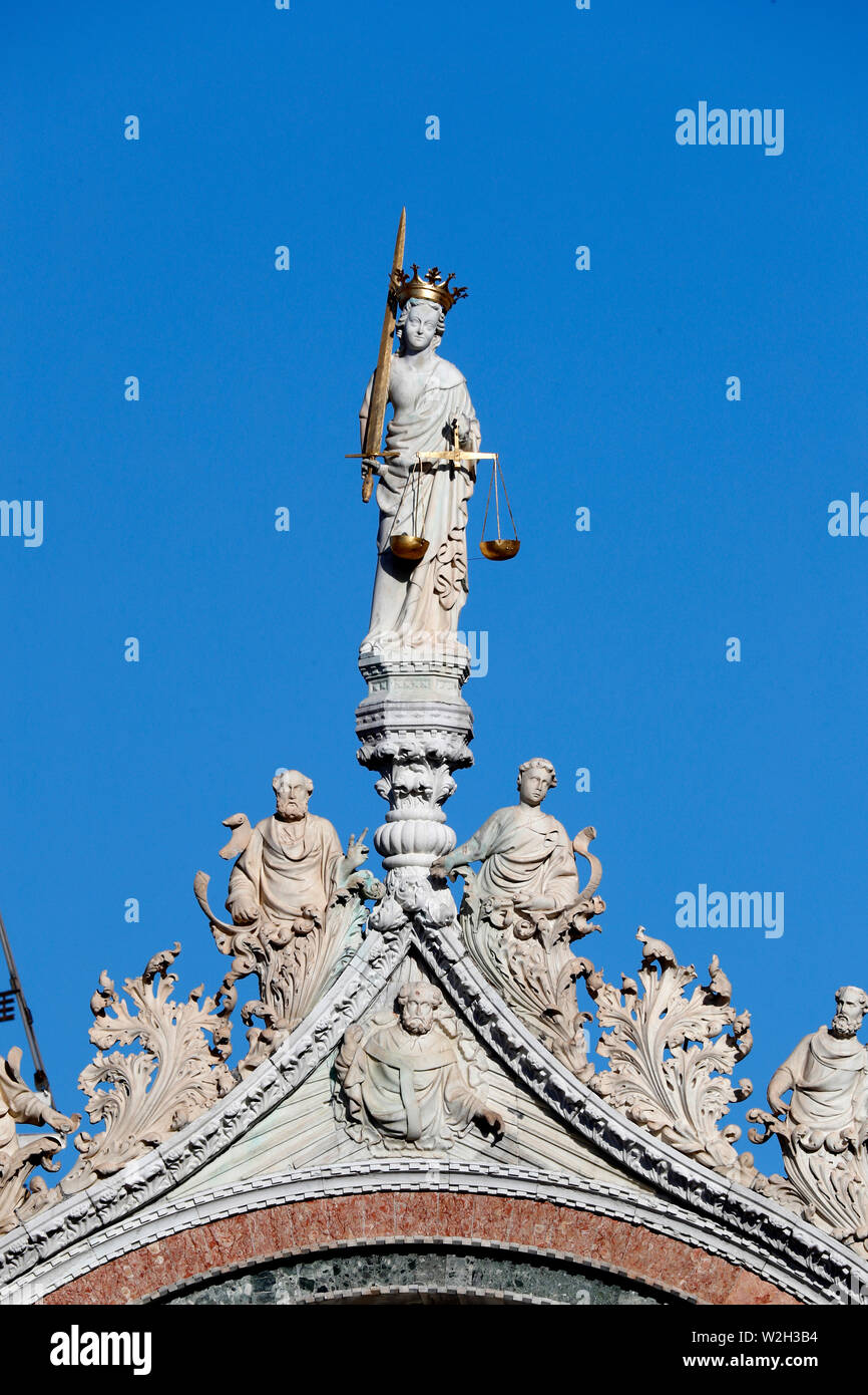 Basilica San Marco. Statue of Justice with her traditional symbols of ...