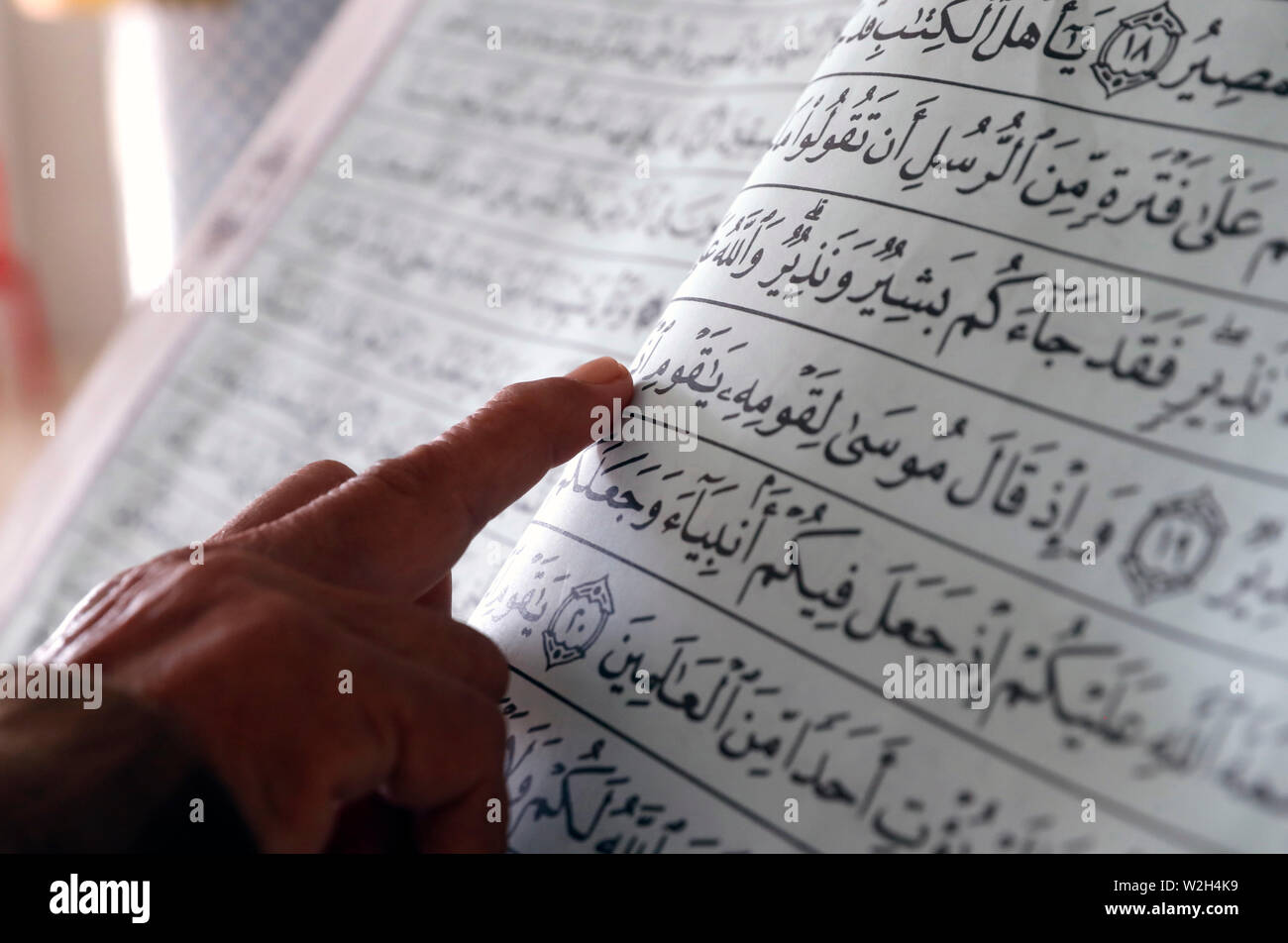 Masjid Nurul Naim mosque. Imam reading the Quran. Close-up. Arabic ...
