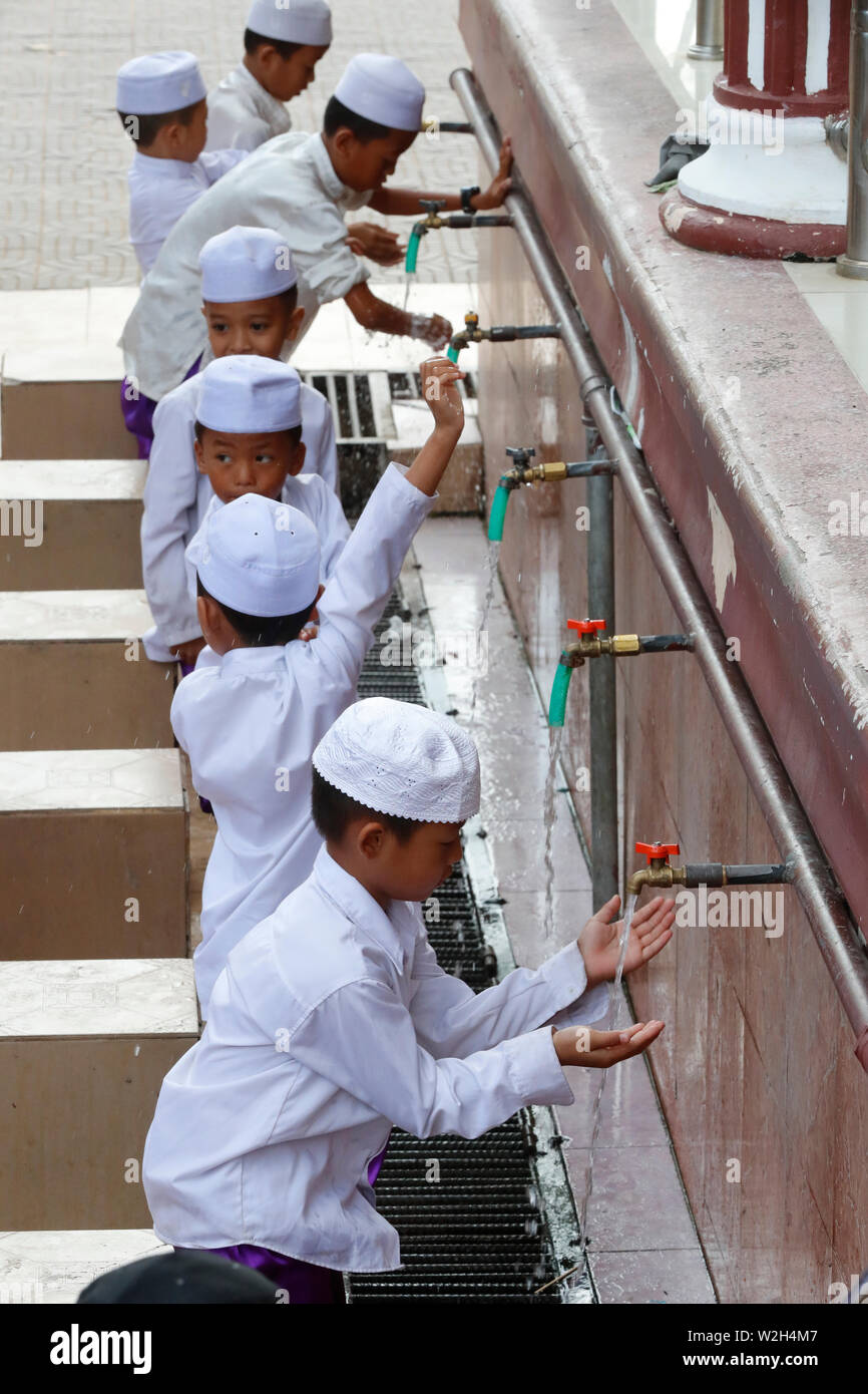 Nurunnaim mosque. Ritual purity in Islam. Muslim boys performing Wudu ...