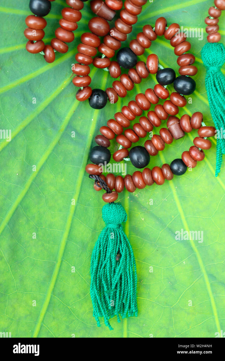 Muslim rosary beads on a green lotus leave Stock Photo - Alamy