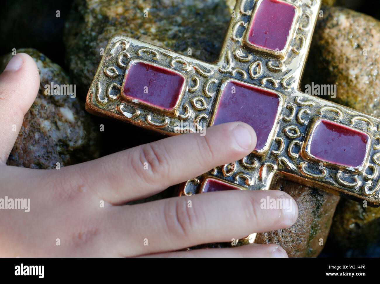 Child hand on a christian cross Stock Photo - Alamy