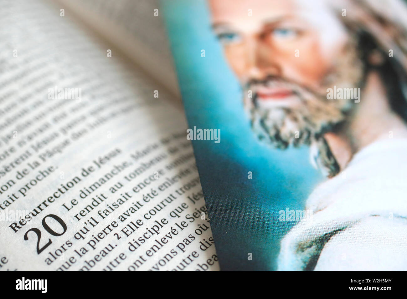 Open bible with an image of Jesus Stock Photo - Alamy