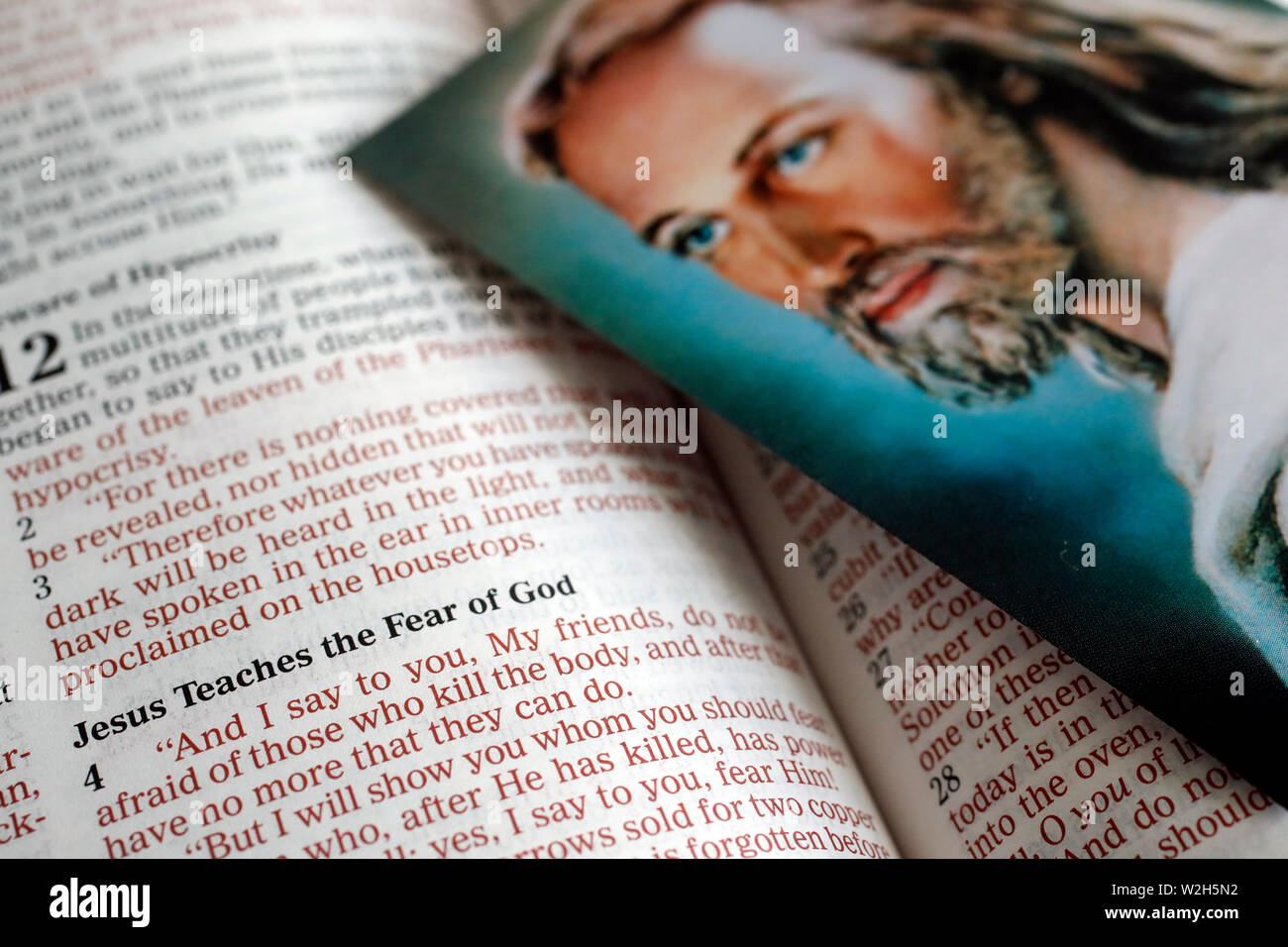 Open bible with an image of Jesus Stock Photo - Alamy