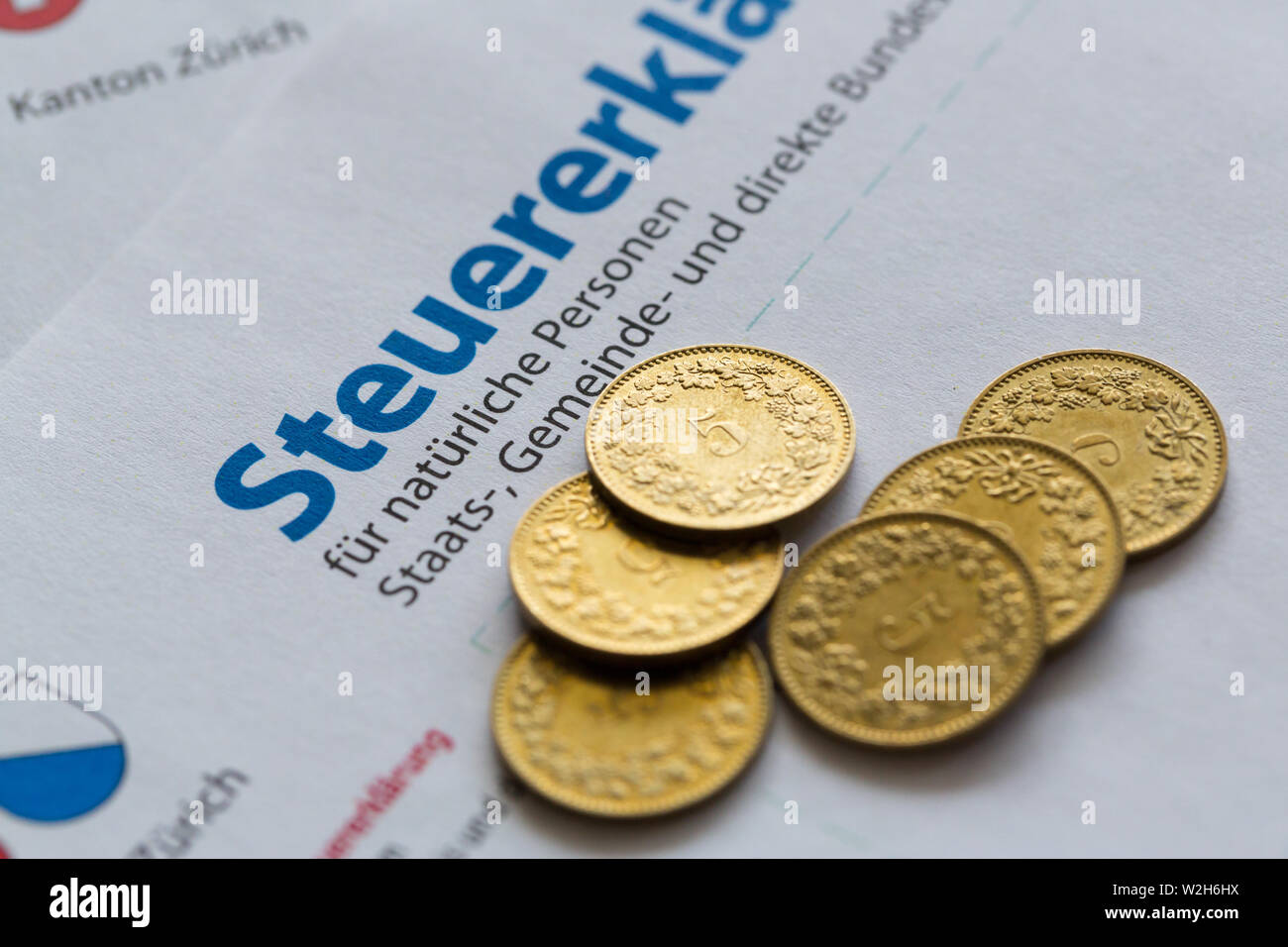 several golden coins on Swiss tax declaration form, Canton of Zurich ...