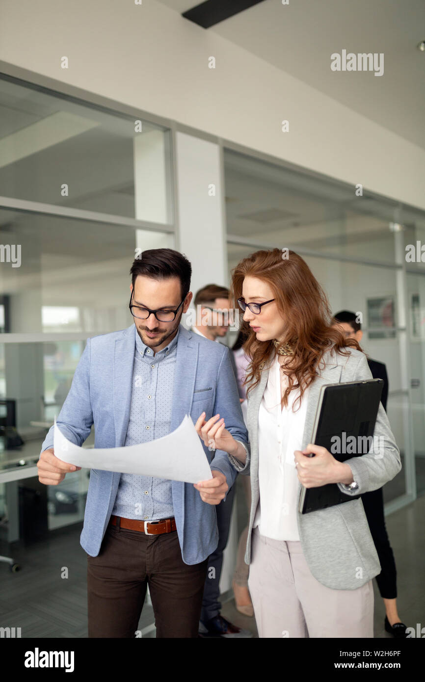 Confident business people reviewing project in office Stock Photo - Alamy