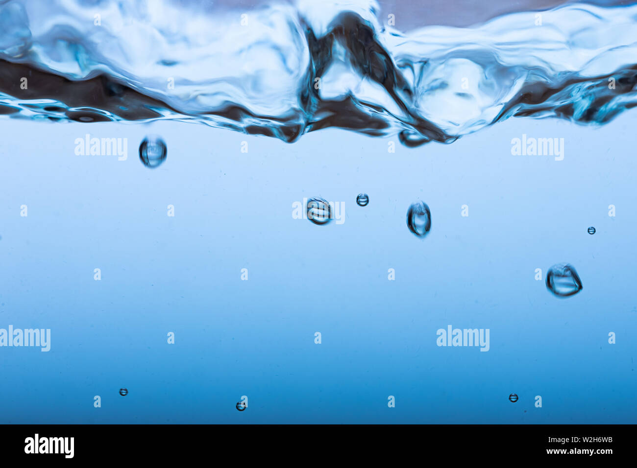 Water splash, clear blue water with waves and bubbless Stock Photo - Alamy