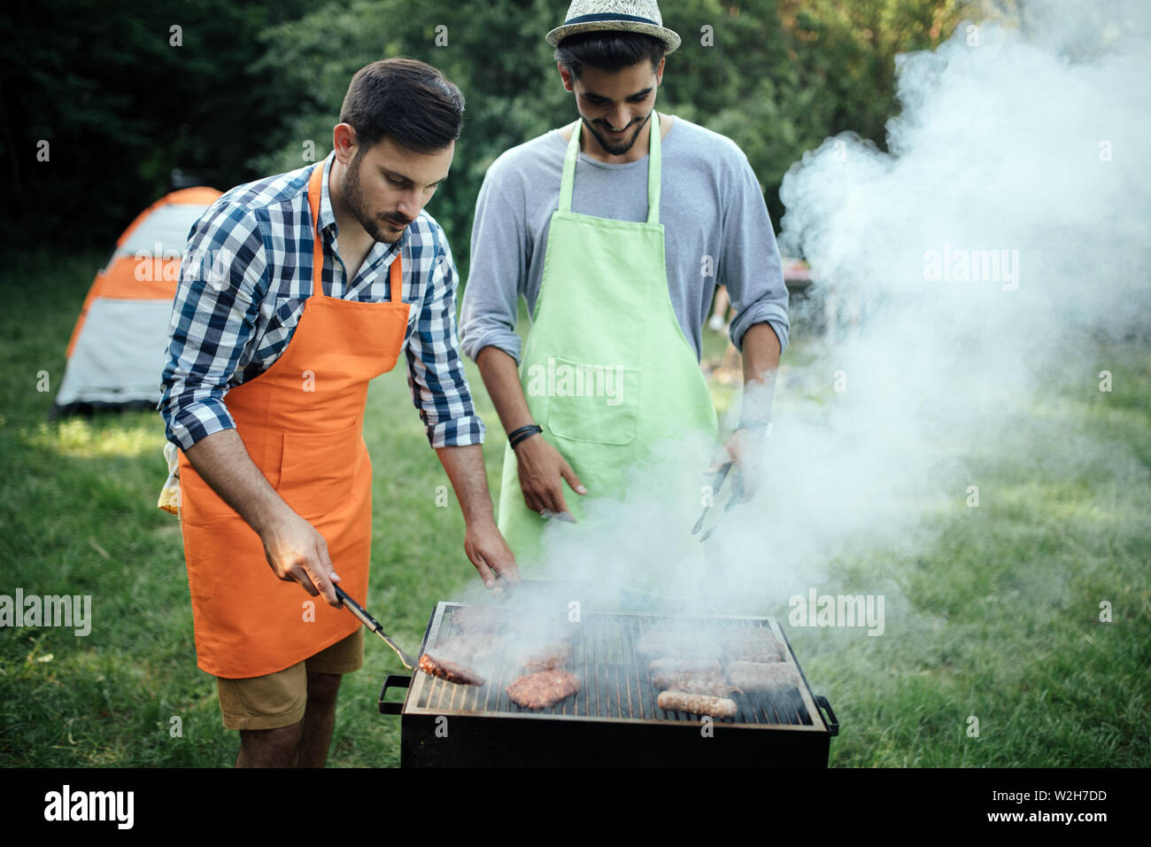 Group of friends having fun in nature doing bbq Stock Photo - Alamy