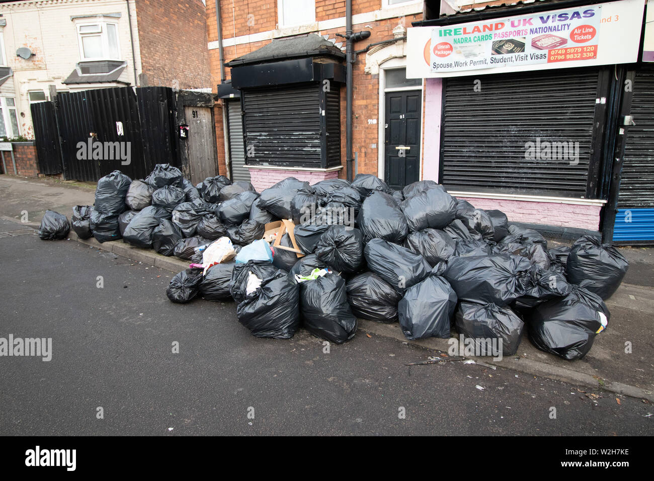 Streets of Birmingham showing uncollected sacks of waste material due ...